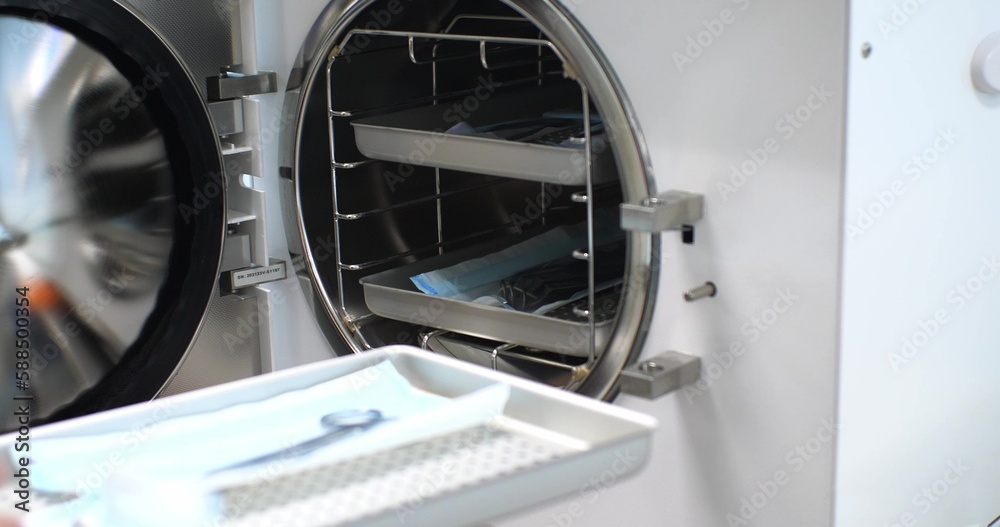 The nurse puts the surgical instrument into the autoclave for ...