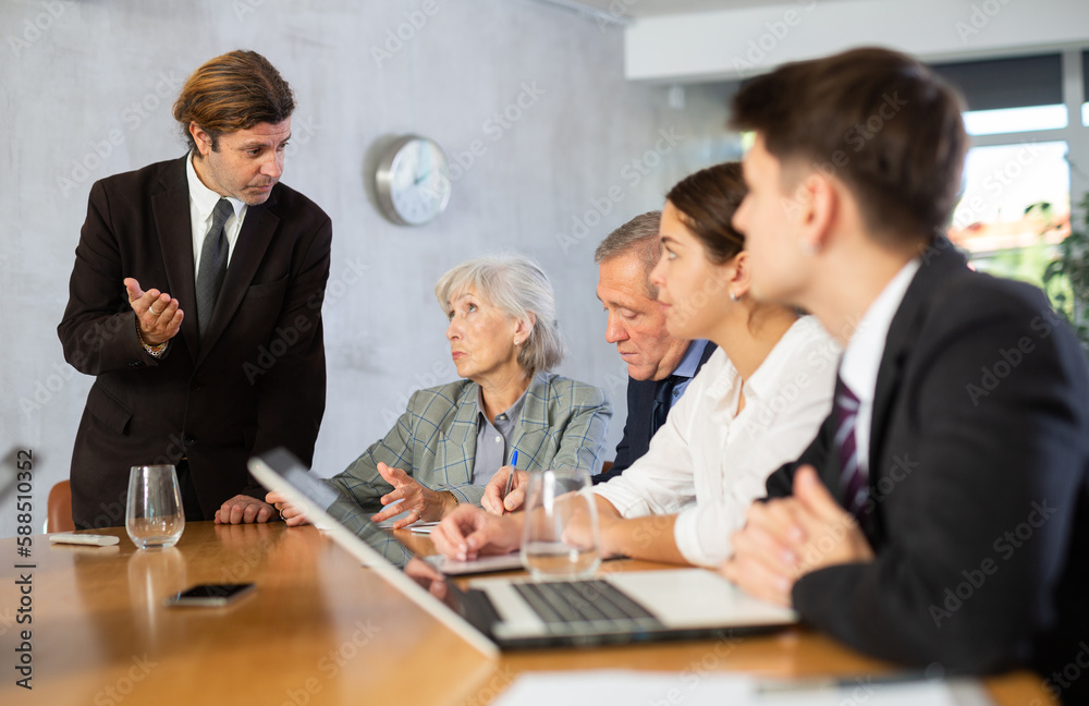 Furious male boss yelling at office colleagues of different ages taking ...