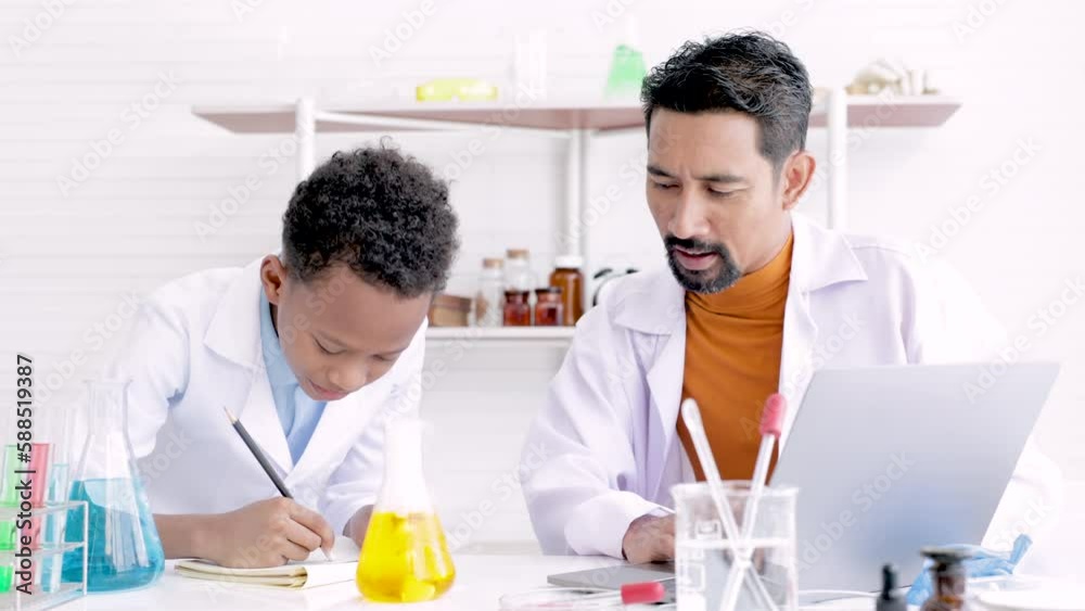 Teacher in white gown and student scientists making experiment in lab ...