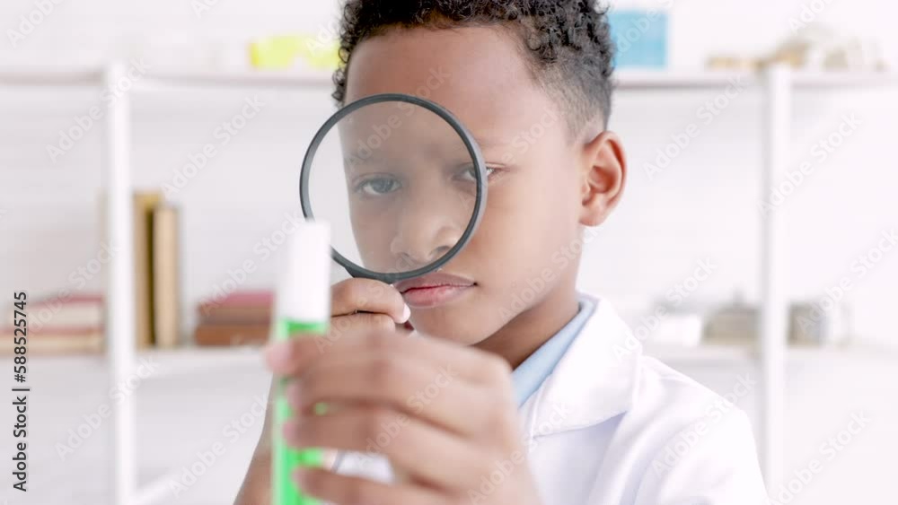African student in white coat notice the exchange of chemical liquid in ...