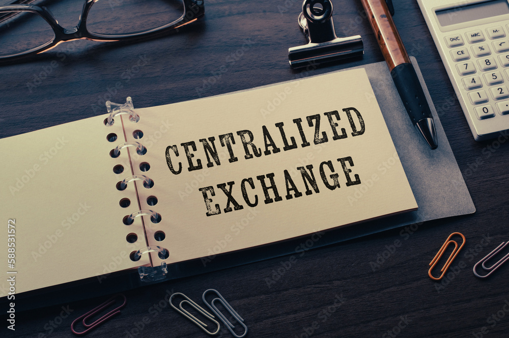 There is note book with the word Centralized Exchange on a laptop. It ...