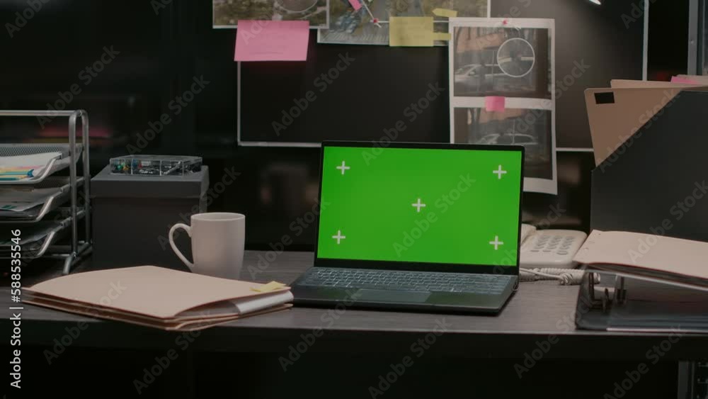 Modern laptop with greenscreen placed on archive desk in police ...
