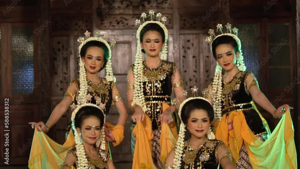 a group of Javanese dancers poses together while wearing jasmine and ...
