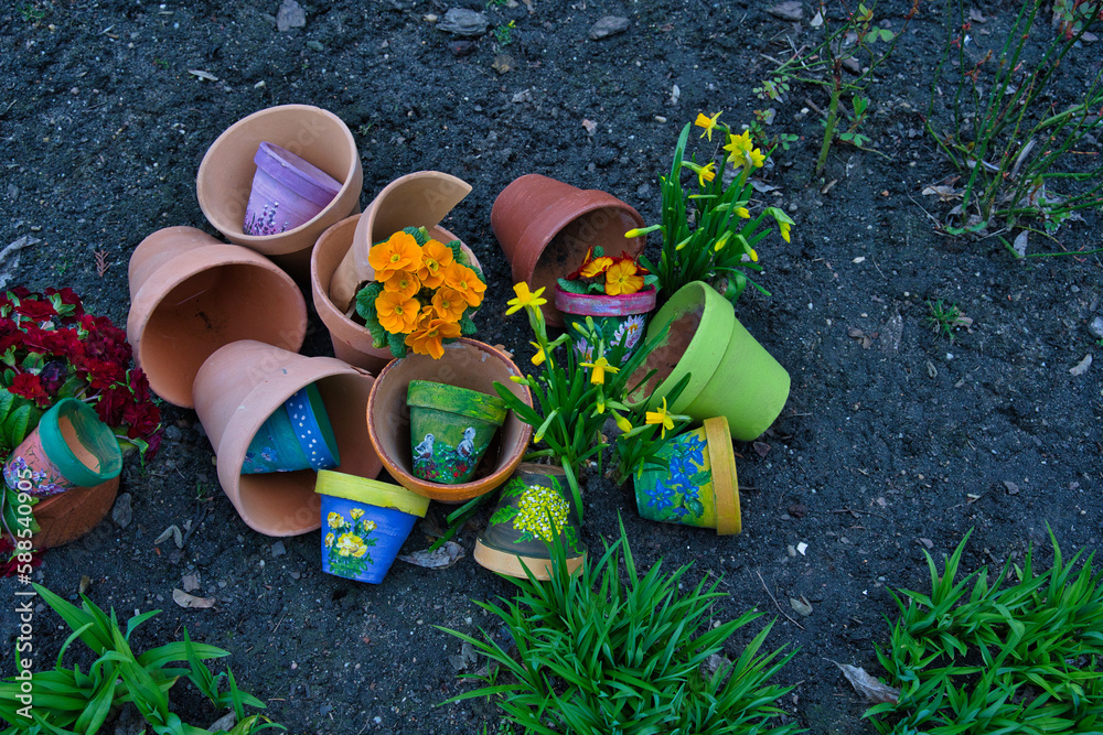 colorful ceramic pots painted in spring patterns lying on the ground ...