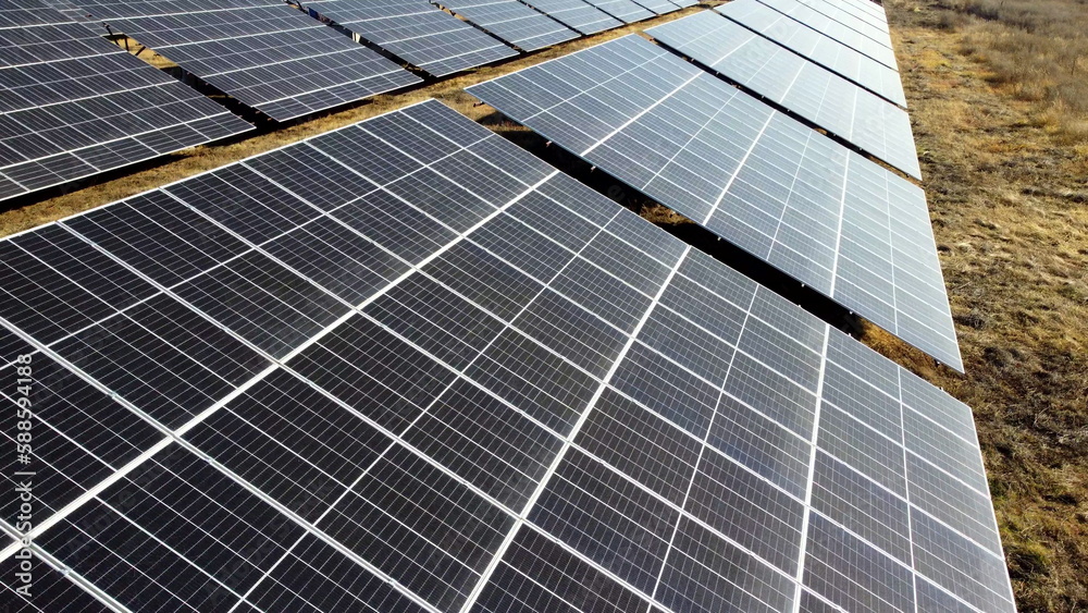 Solar power plant. Flight over modules of solar power station on sunny ...