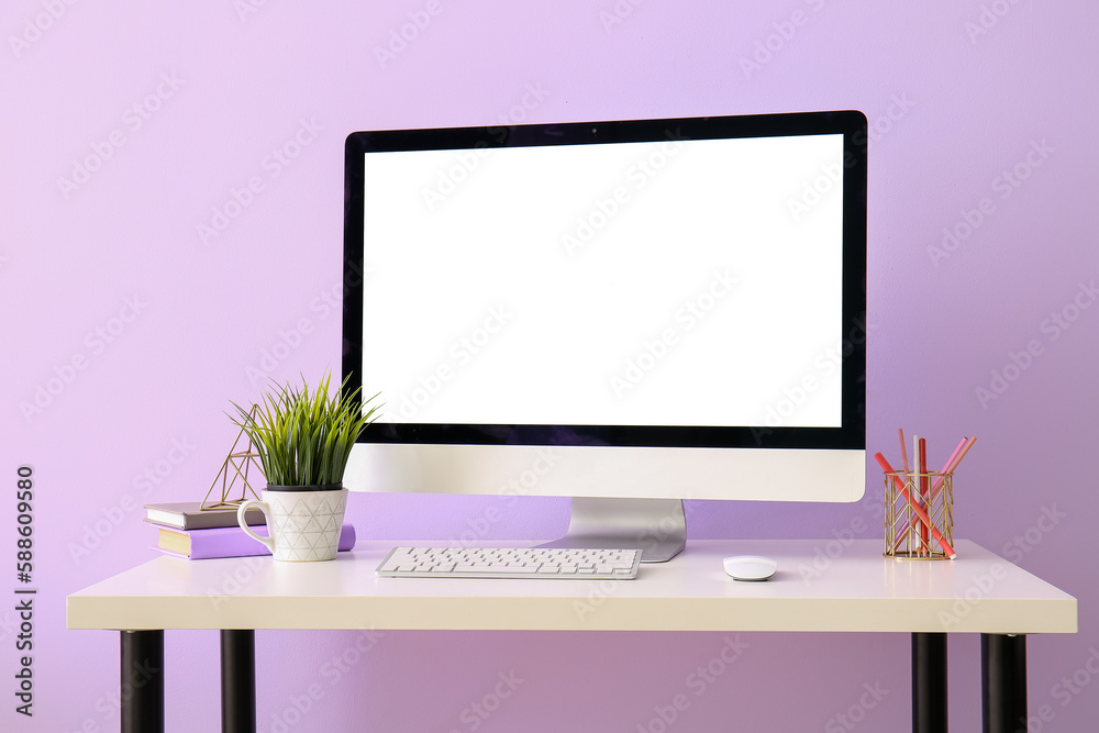 Workplace with computer and stationery near lilac wall Stock Photo ...