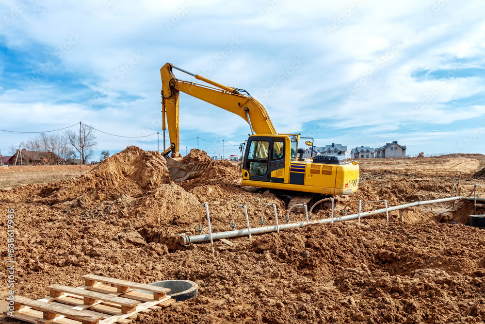 Excavator dig the trenches at a construction site. Trench for laying ...