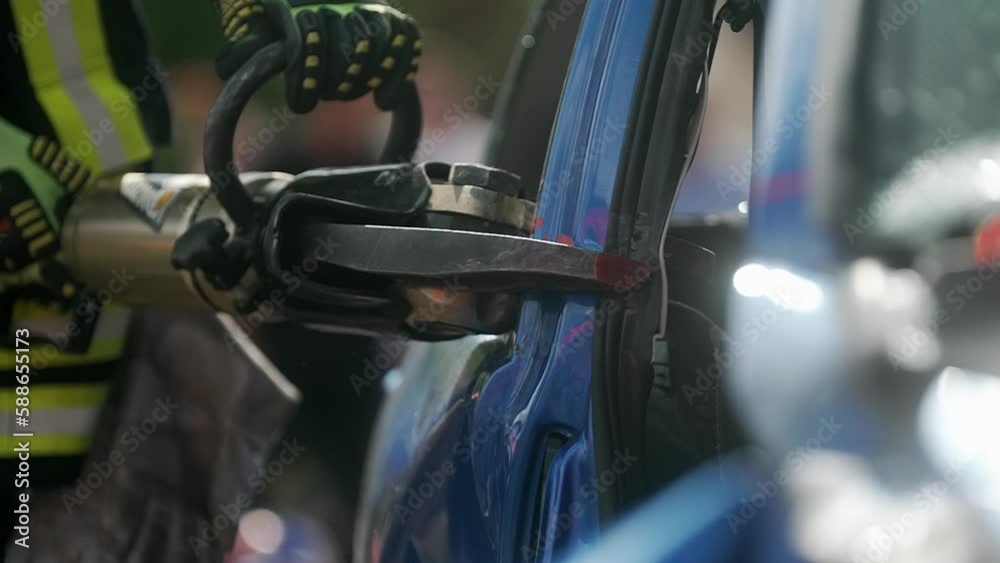 Firefighters cutting the car after accident using hydraulic pilers in ...