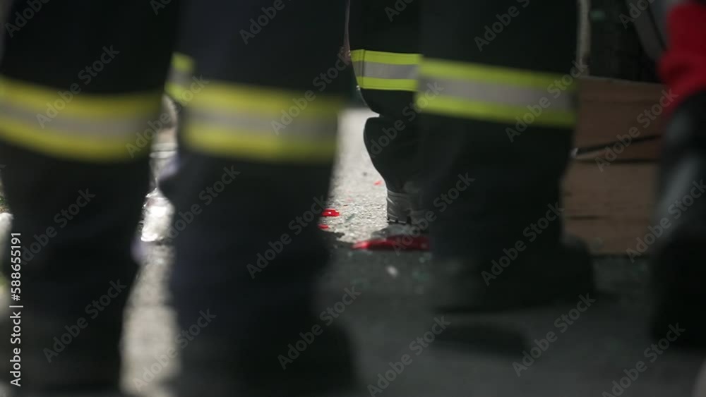 Shattered glass falling on the ground next to the firefighters legs in ...
