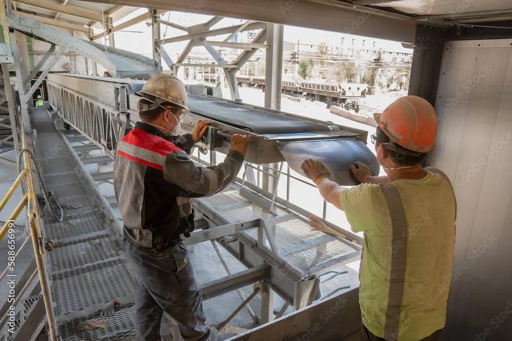 Loading and unloading works, manual labor. A pair of movers stand by a ...