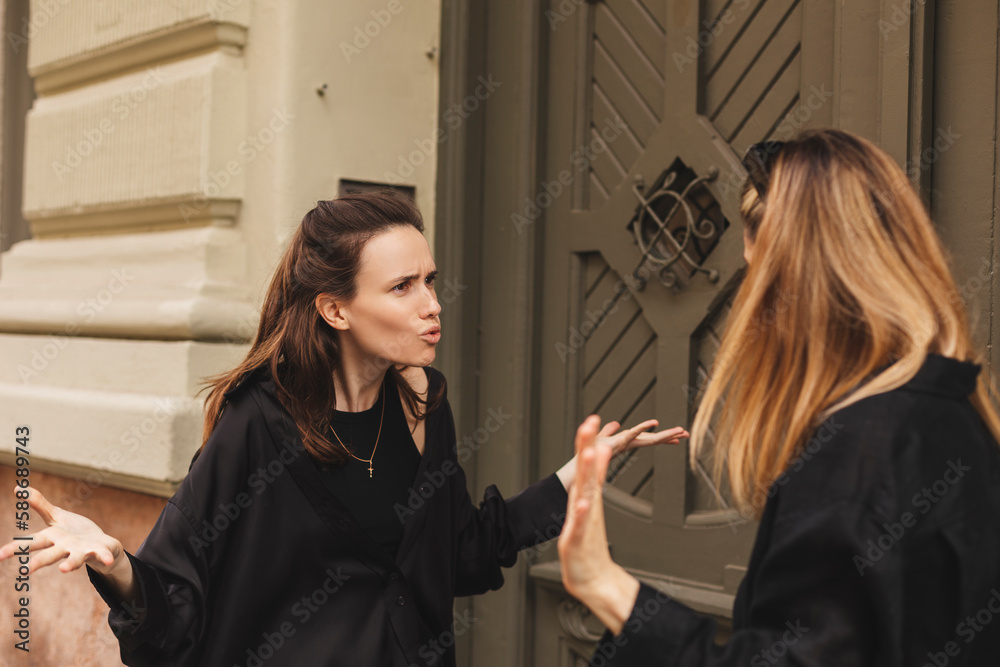 Quarrel two friends. Two women screaming at each other. Two young women ...
