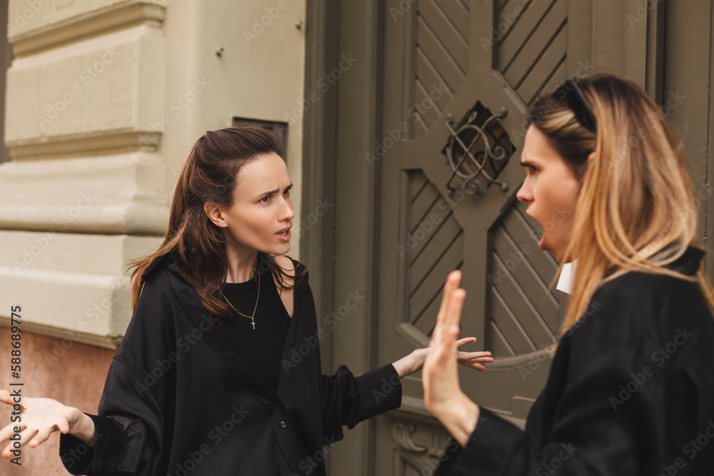 Quarrel two friends. Two women screaming at each other. Two young women ...