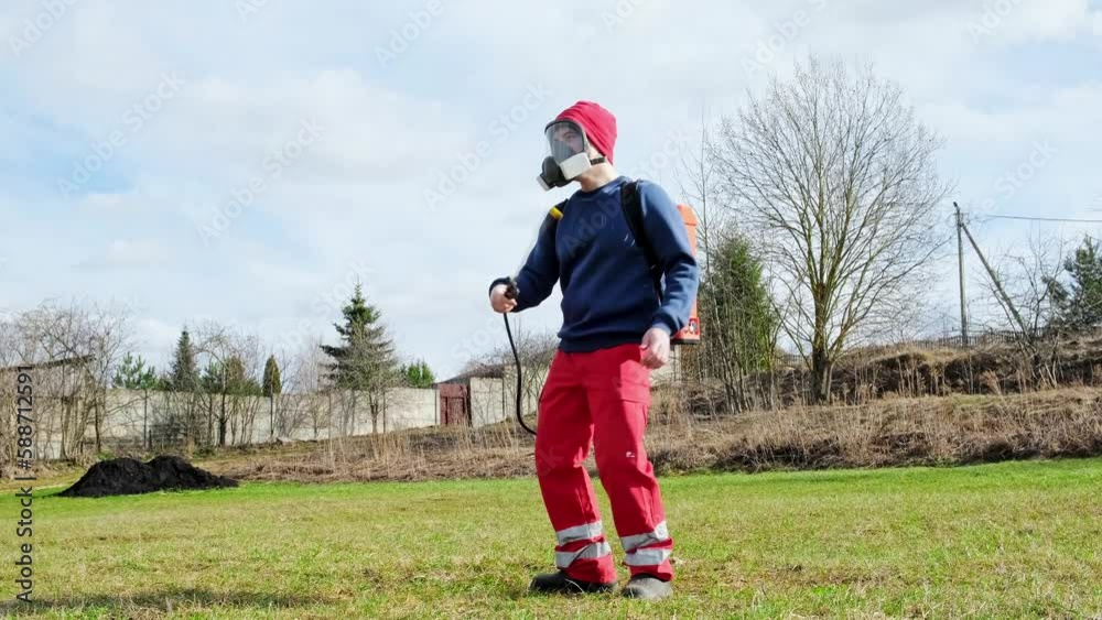 Unusual happy dance. Dancer man gardener is dancing in spraying in PPE ...
