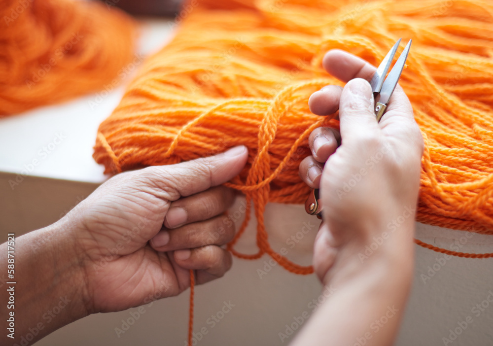 Hands threading and working in an industrial cotton weaving factory ...