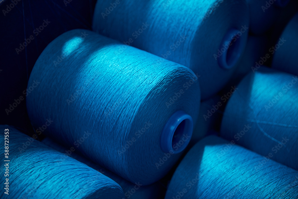 Blue rolls of industrial cotton in weaving factory, hand weaving cotton ...
