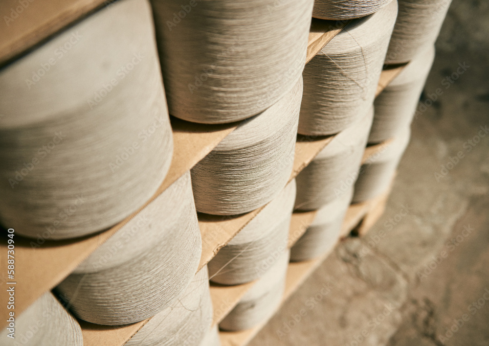 Raw spindles of industrial cotton in a weaving factory, hand weaving ...