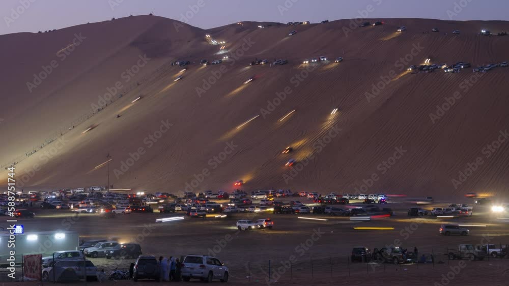Liwa Moreeb dune car race festival in Abu Dhabi, visitor enjoy riding in the tallest sand dune ...
