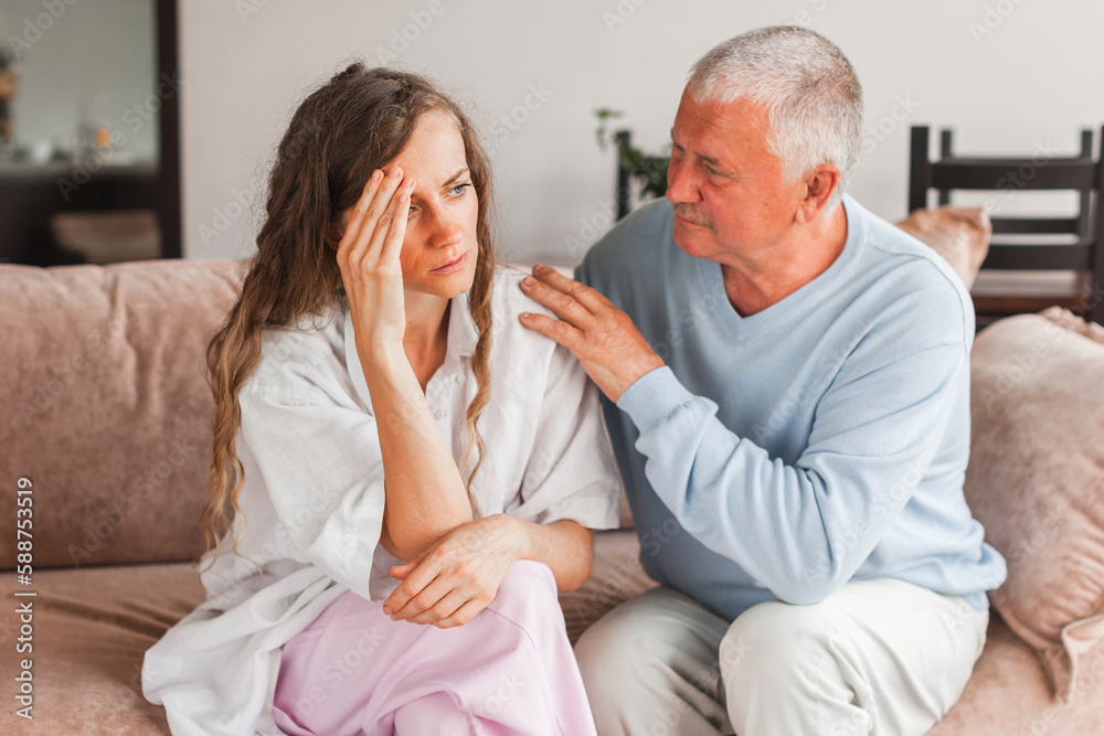 Worried aged father embracing comforting sad grown up daughter with ...