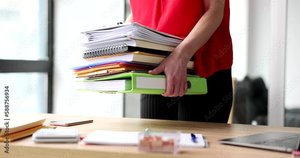 Female hands hold a stack of business folders and documents. Office ...