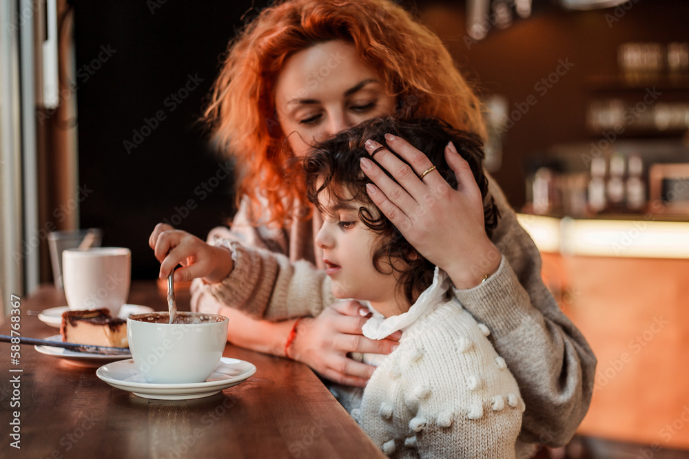 Beautiful Young Red Haired Mother With Cute Curly Haired Daughter Are