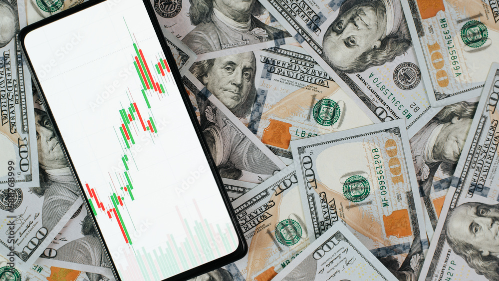 Graph of stock exchange on screen of smartphone lying on money ...