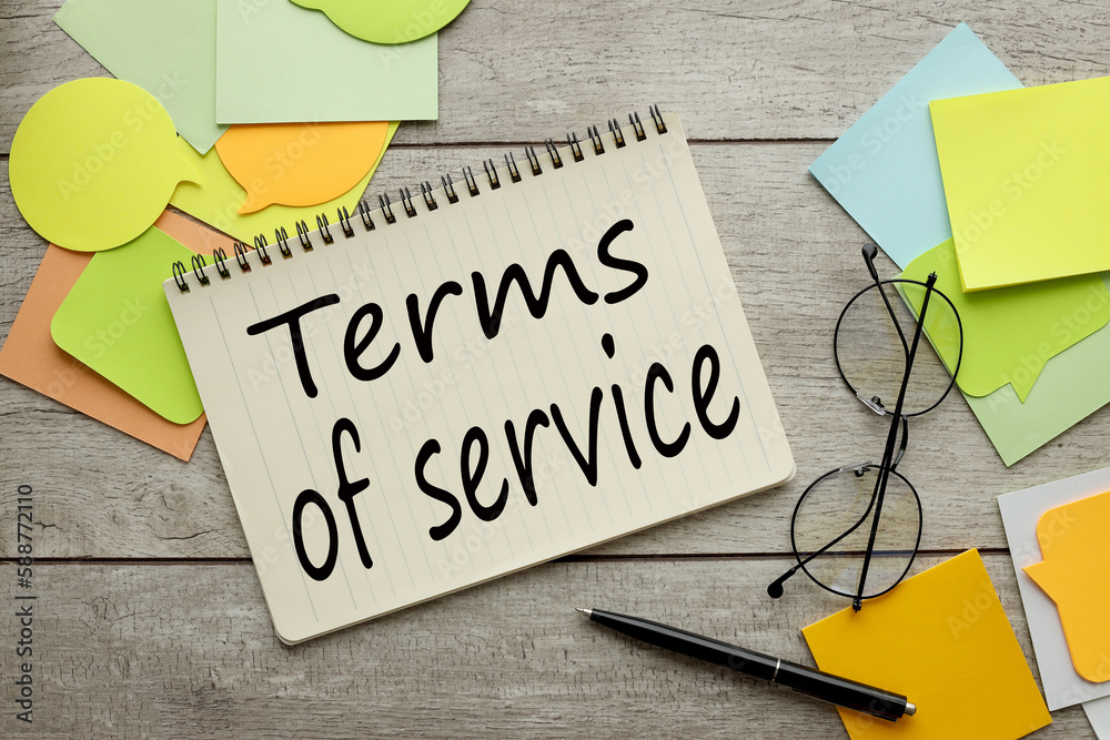 Terms of servise. a lot of stickers are scattered on a wooden ...