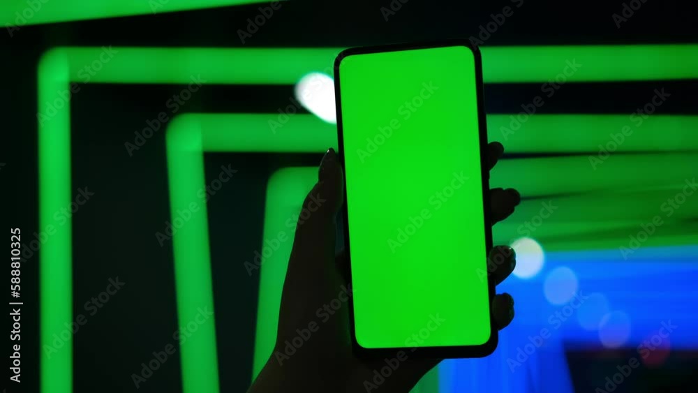 Woman using Chroma Key Smartphone while Standing, Gesturing, Swiping, Scrolling. Night City ...