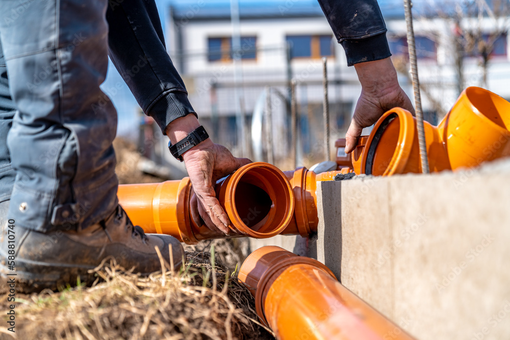 installation of a sewage plastic pipe during the construction of a ...