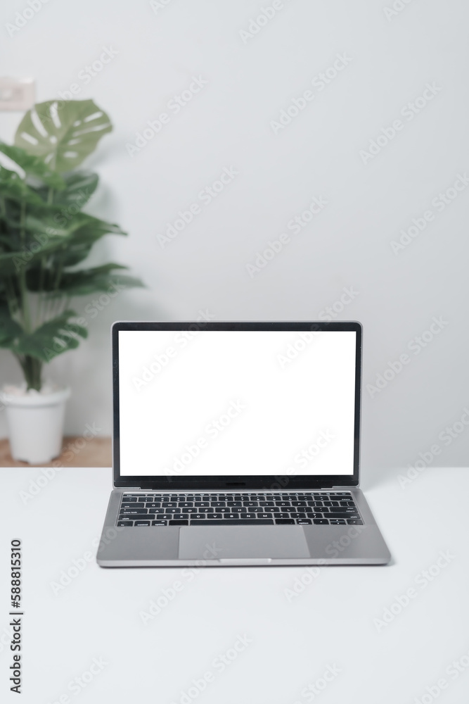 Blank screen of laptop pc computer on white desk table with monstera ...