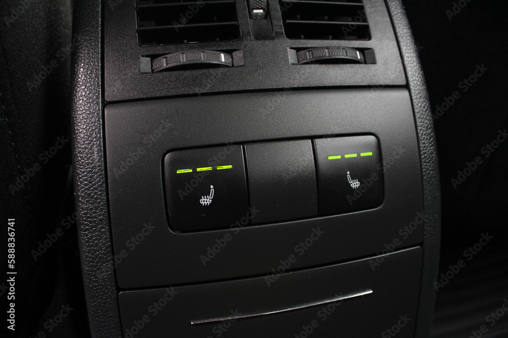 Switch to activate the heater in the car seats. foto de Stock | Adobe Stock