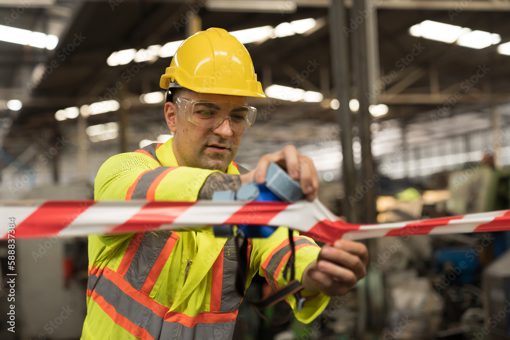 Male factory worker marking line symbol signal no entry area to ...