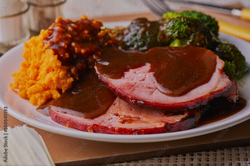Gammon roast dinner with a rich gravy pored over the top. Stock Photo ...