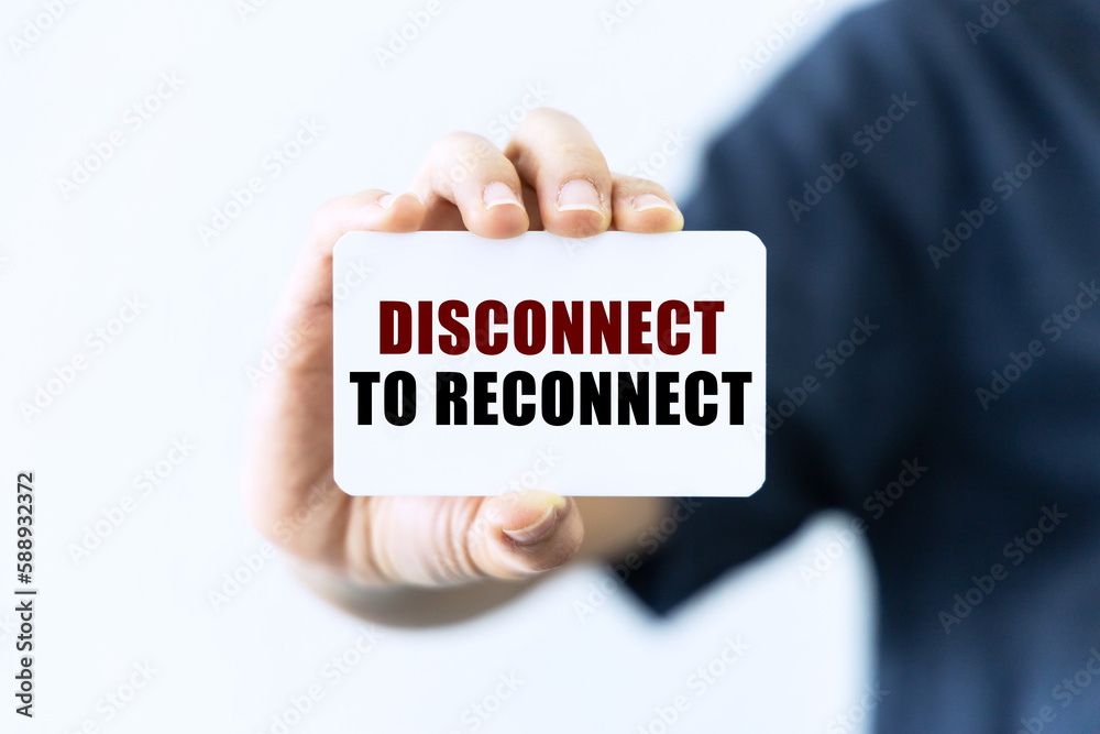 Disconnect to reconnect text on blank business card being held by a ...
