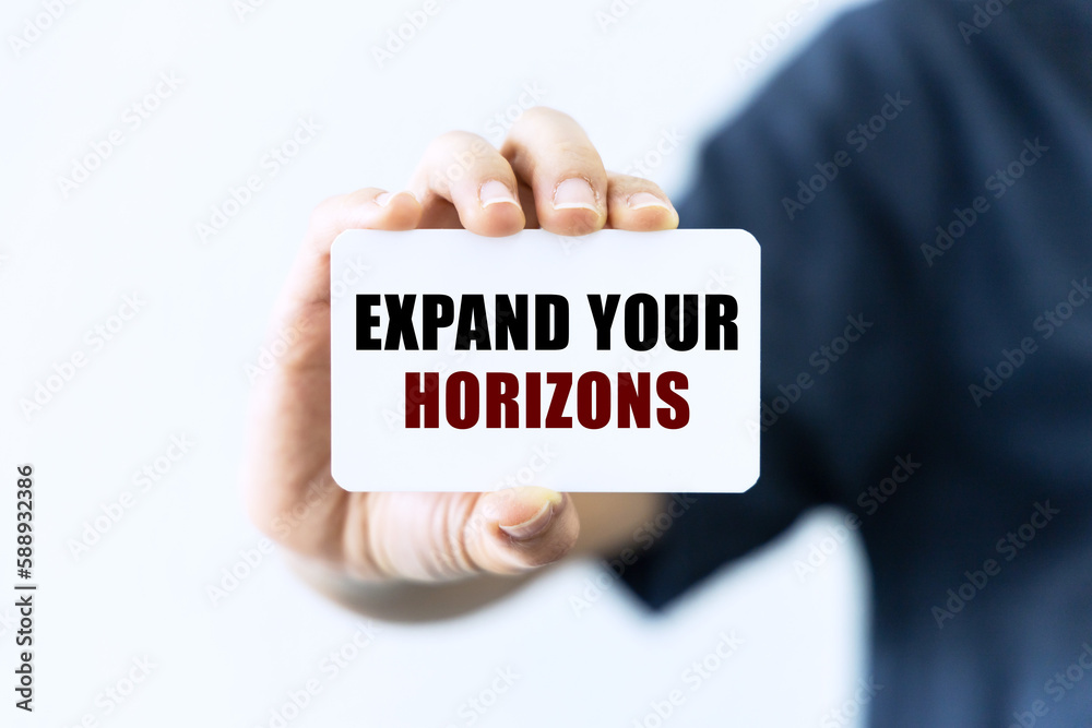 Expand your horizons text on blank business card being held by a woman ... Expand your horizons text on blank business card being held by a woman ...