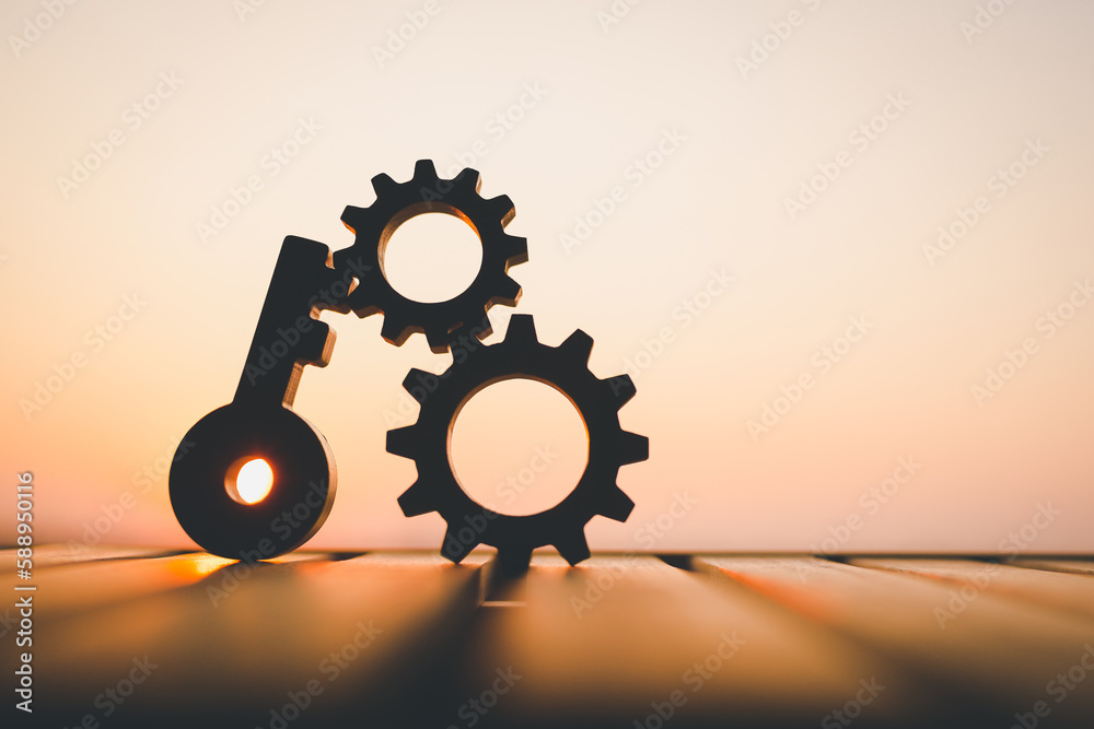 Key model and gear model with evening sky Key concepts for success ...