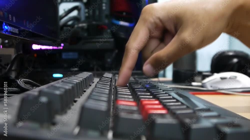 Footage of a man hand typing on his mechanical gaming RGB keyboard ...