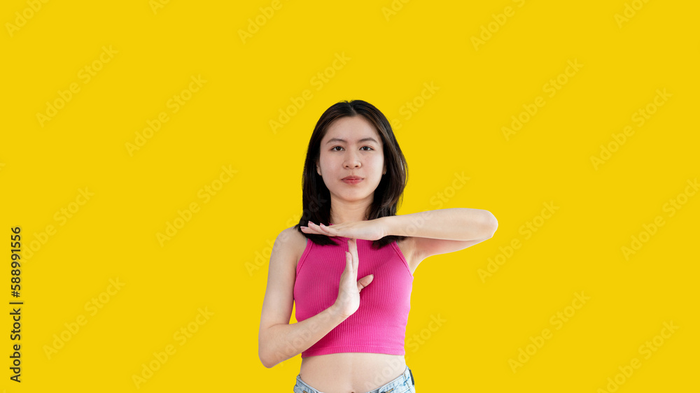Woman makes a T hand sign indicating a request for a time-out or a ...
