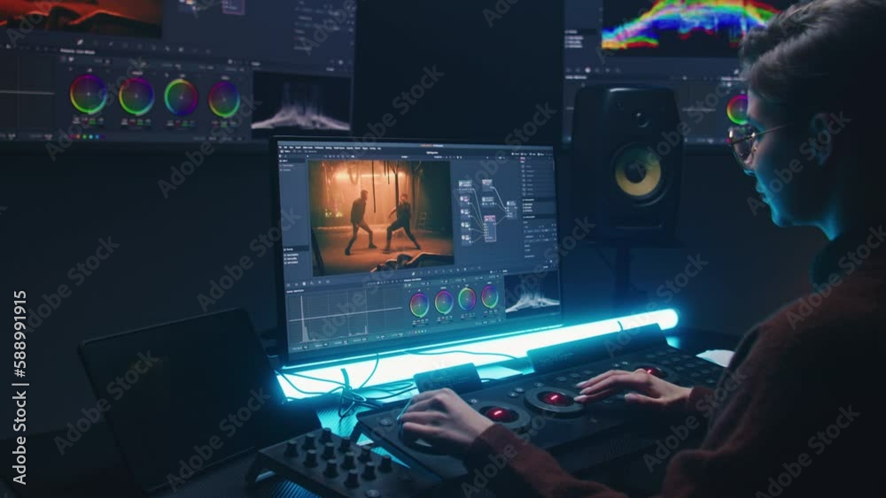 Female editor uses color grading control panel, edits video, makes ...