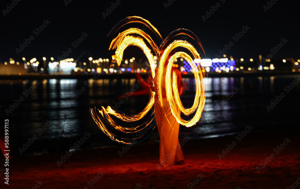 Fire dancers, swing fire dancing show. Create shapes from fire on a ...