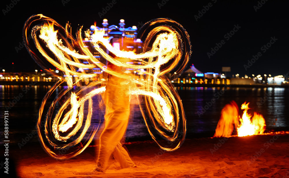 Fire dancers, swing fire dancing show. Create shapes from fire on a ...