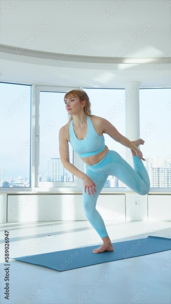 Fit adult woman practicing Yoga Sequences of Dancer Pose and Standing ...