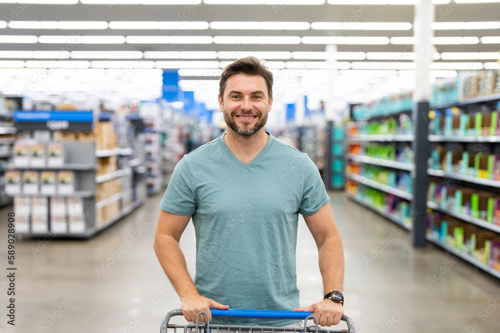 Man with grocery shopping trolley shopping at supermarket. Grocery ...