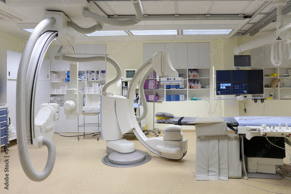 A modern hospital room, a large portable mobile scanning machine with ...