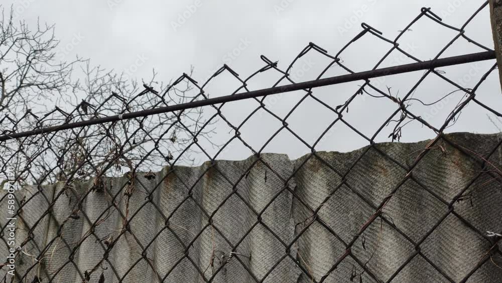 fence made of metal and concrete. steel mesh. mesh fence. gray concrete ...