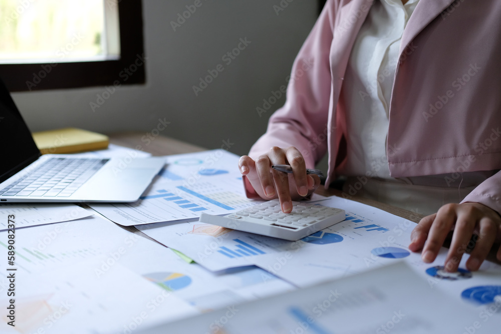 Deduction planning concept. Asian young woman hand using calculator to ...