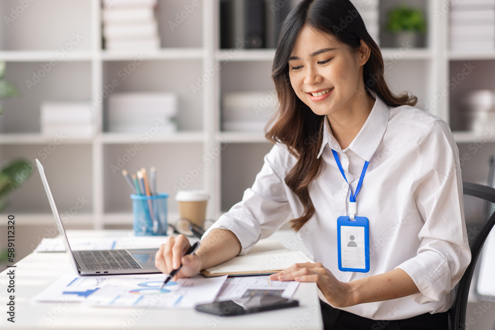 Charming Young asian businesswoman sitting on laptop computer in the ...