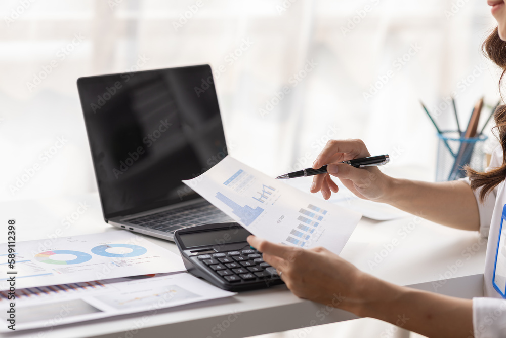 Charming Young asian businesswoman sitting on laptop computer in the ...