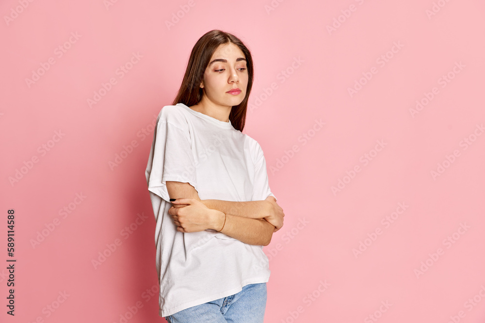 Portrait of young girl in casual clothes posing with sad face against ...