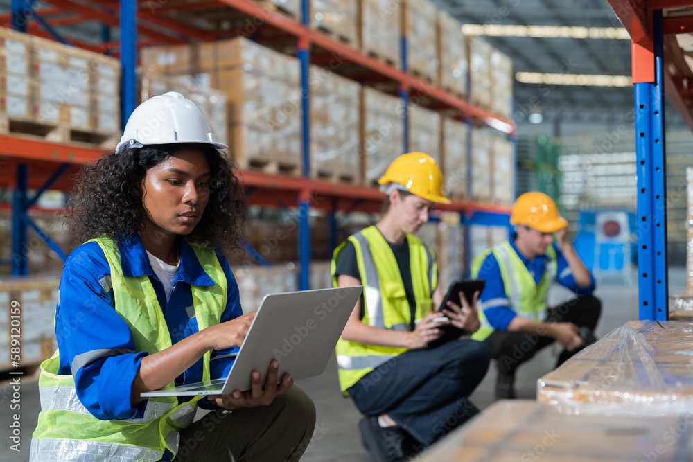 Male and female warehouse worker wearing uniform checks stock inventory ...