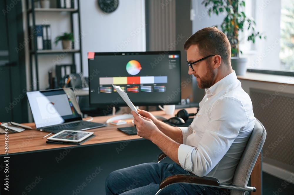 Graphic designer is sitting. Man in formal clothes is working in the ...